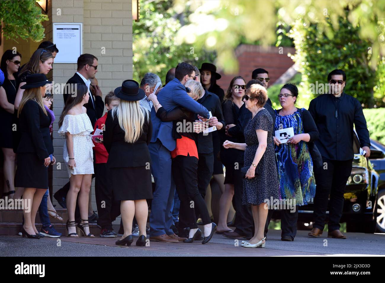 The husband of Cindy Low, Matthew (centre) is embraced as he departs ...