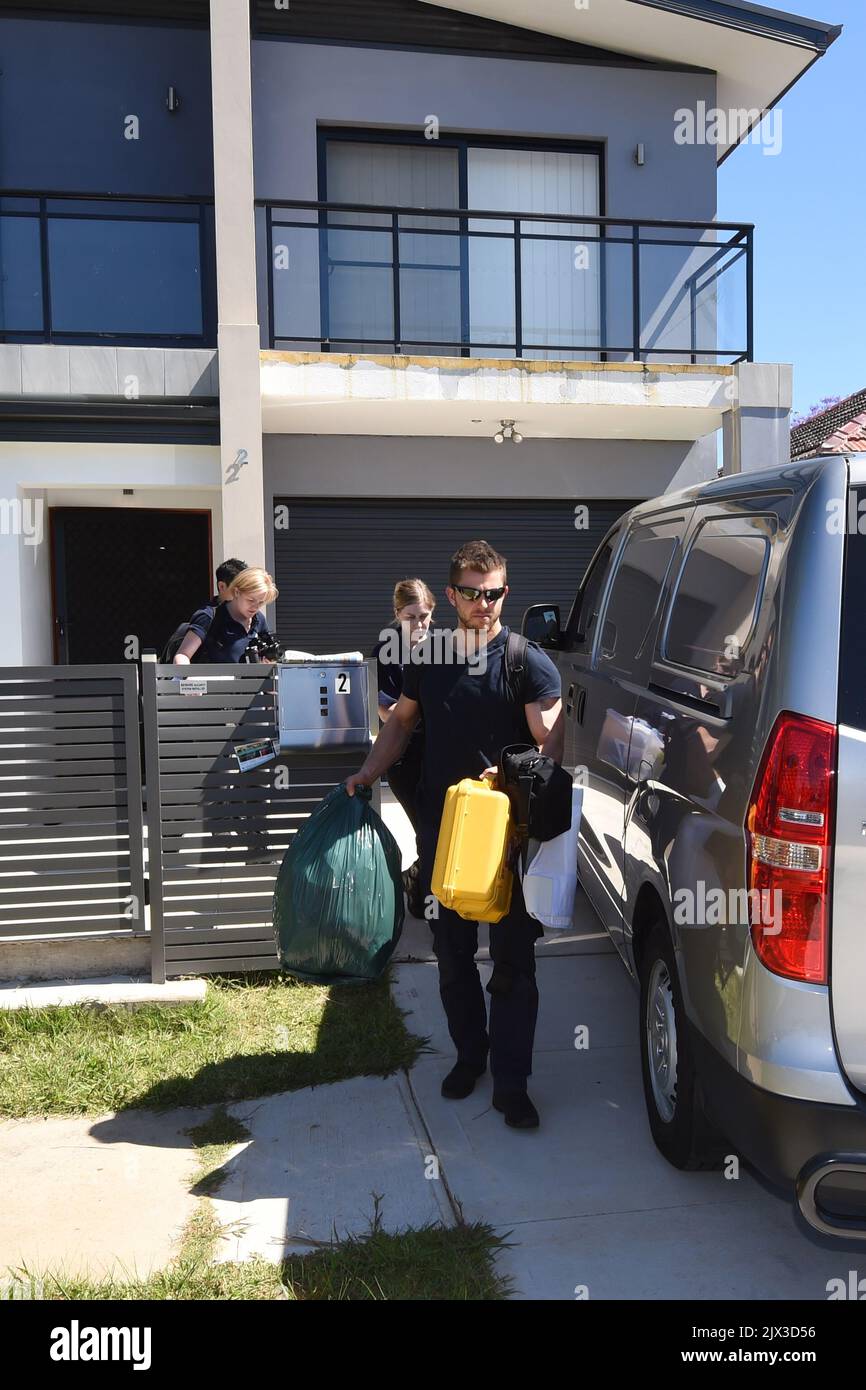 Australian Federal Police emerge from a home in Merrylands following ...