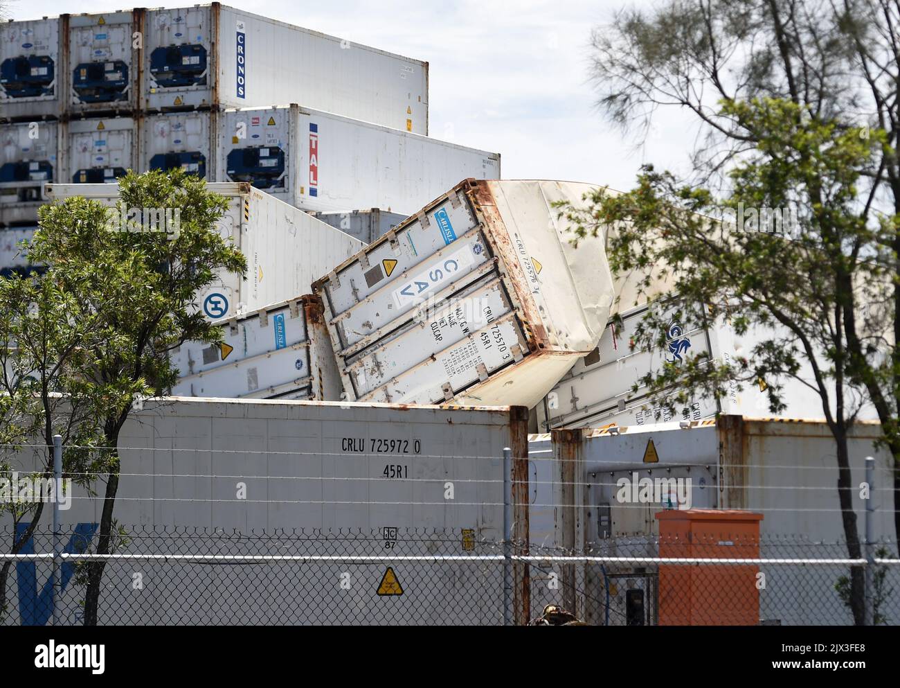 Shipping containers are seen toppled at the Port of Brisbane, Monday ...