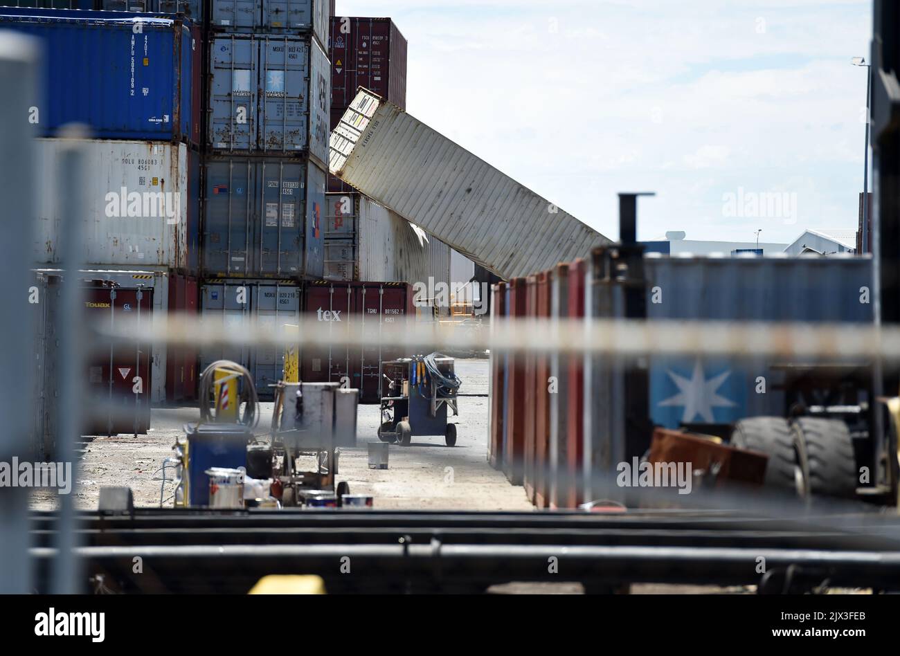 Shipping containers are seen toppled at the Port of Brisbane, Monday ...