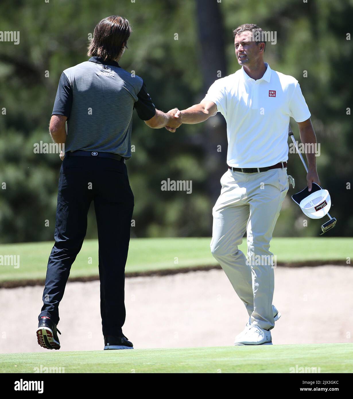 Australia's Adam Scott (right) shakes hands with playing partner Aaron ...