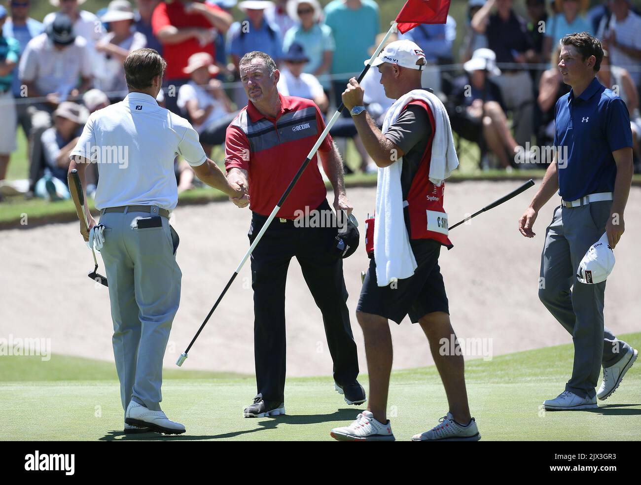 Australia's Rod Pampling (2nd left) shakes hands with playing partner ...