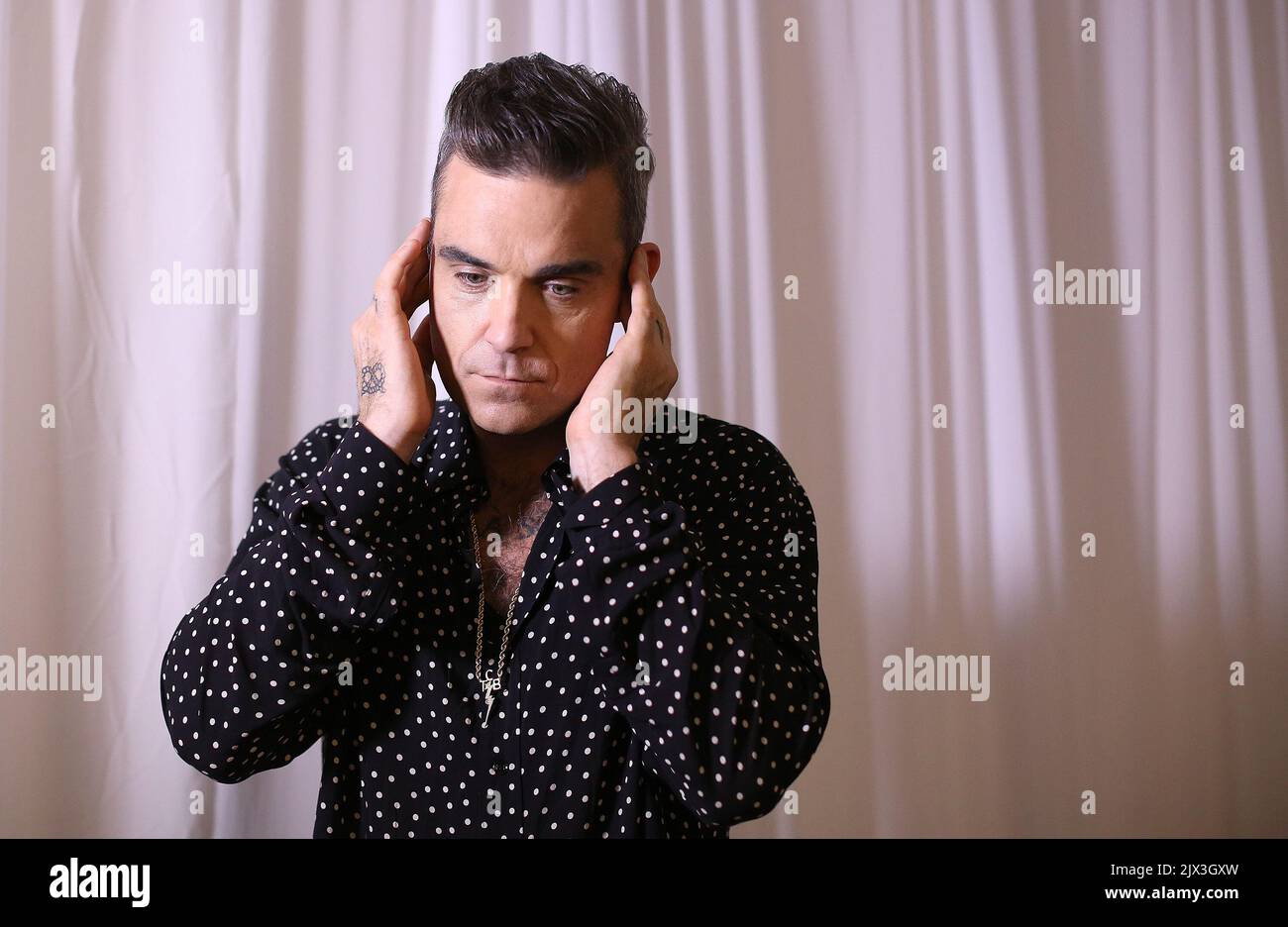 English Singer Robbie Williams poses for a photograph in Sydney, Monday ...