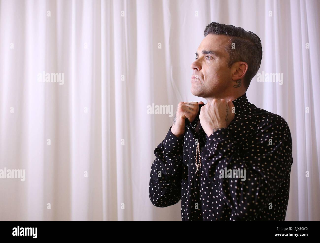 English Singer Robbie Williams poses for a photograph in Sydney, Monday ...