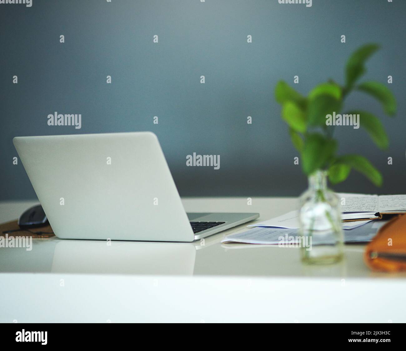 Its a creative workspace. a laptop on a desk in a creative business ...