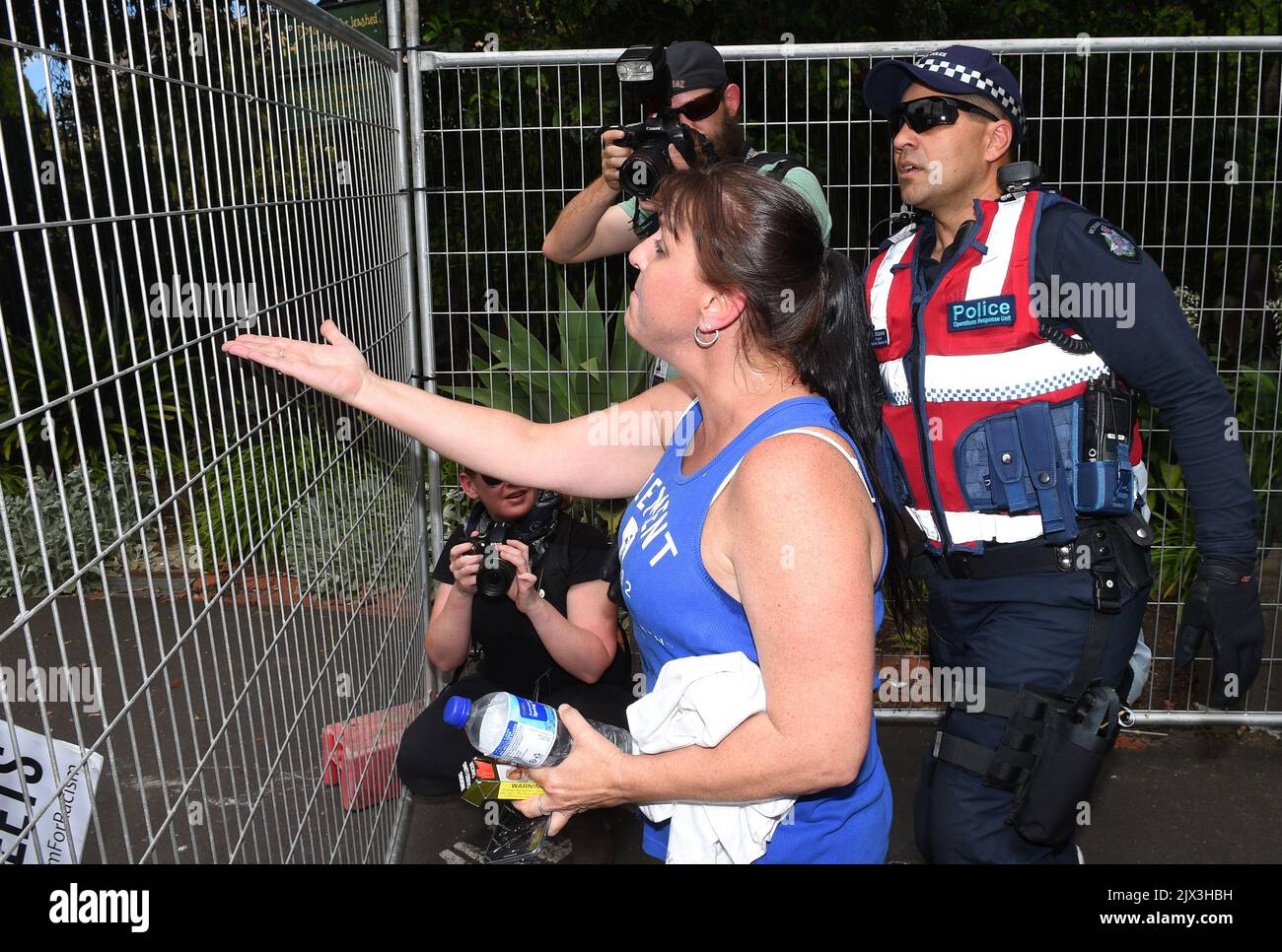 A woman attending the True Blue Crew and United Patriots Front (right ...