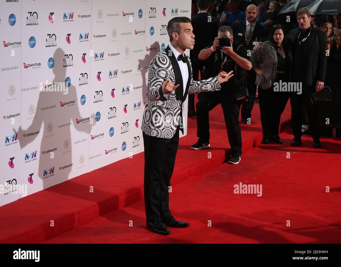 British singer Robbie Williams poses for photographers as he arrives to ...