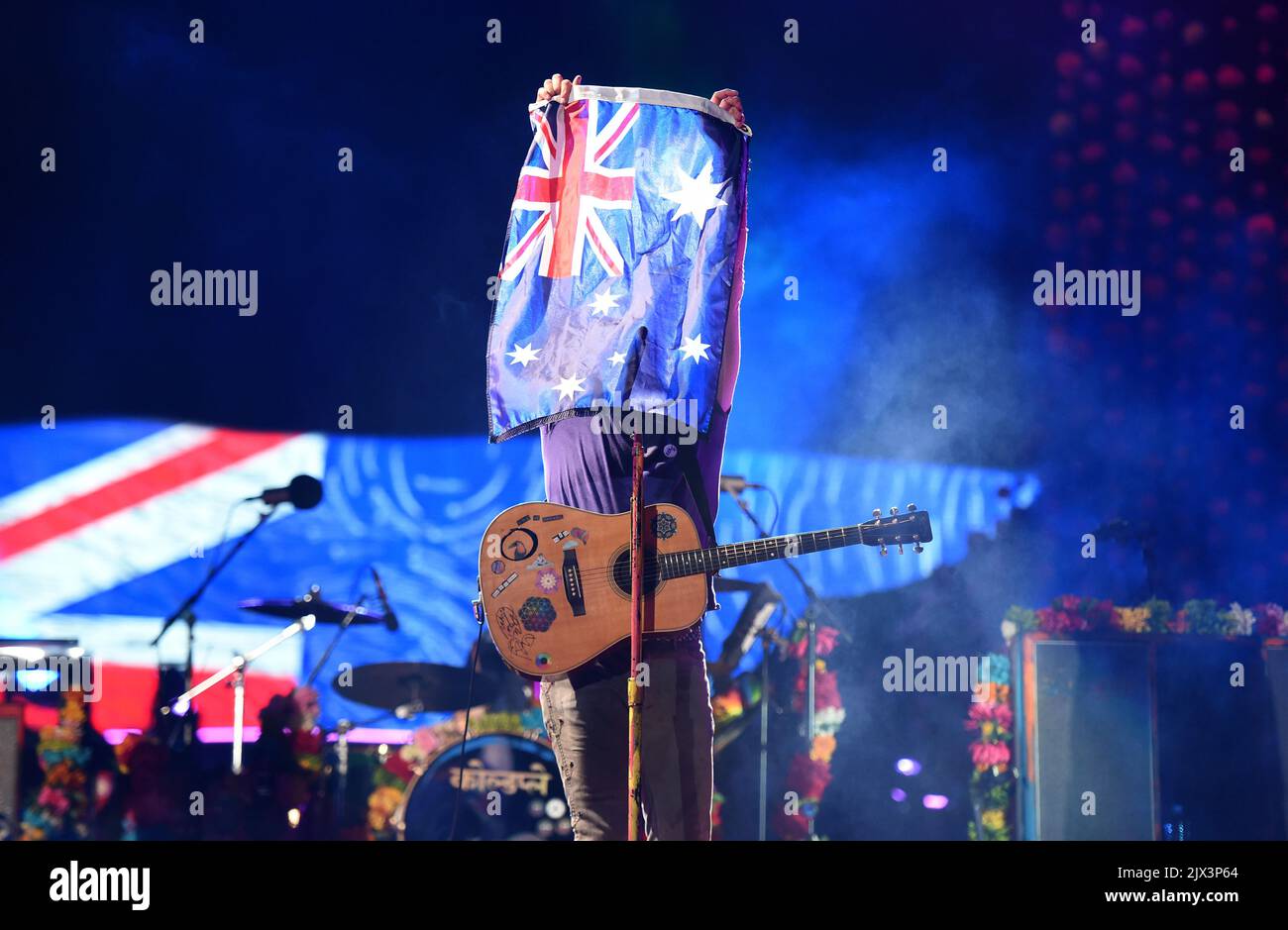 Chris Martin, lead singer of British rock band Coldplay, holds up the ...