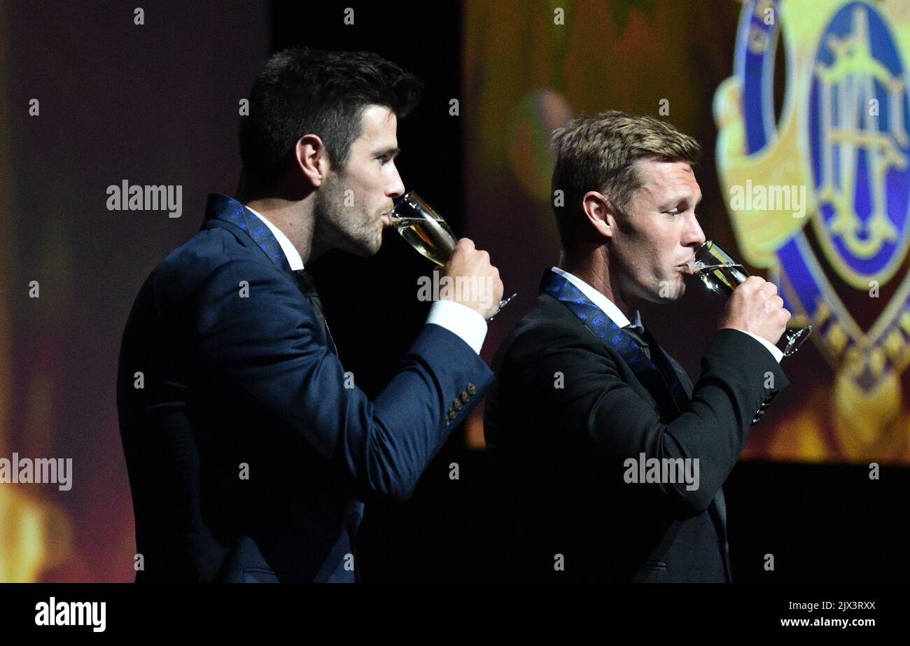 AFL players Trent Cotchin (left) and Sam Mitchell are seen on stage ...