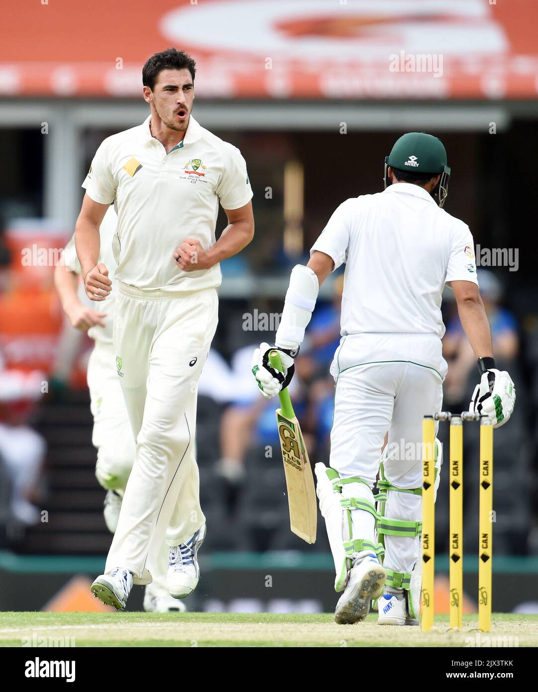 Australian bowler Mitchell Starc (left) looks at Pakistan's Azhar Ali ...