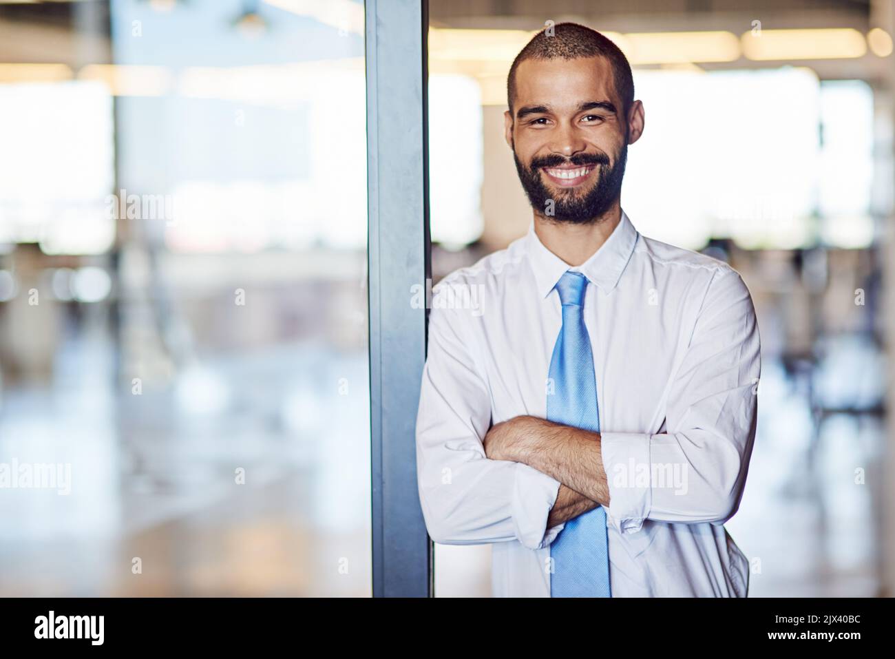 Trust me to get the job done with a smile. Portrait of a smiling young ...