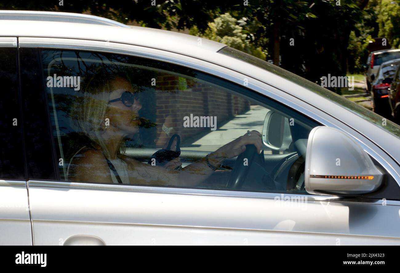 Tania Hird leaving her family home in Toorak, while her husband James ...