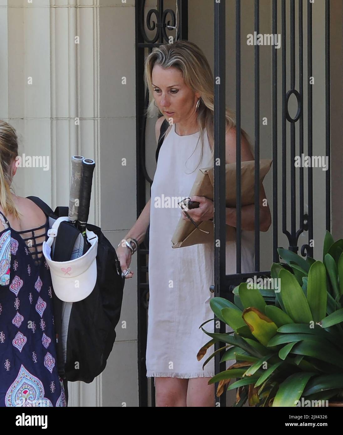 Tania Hird leaving her family home in Toorak, while her husband James ...