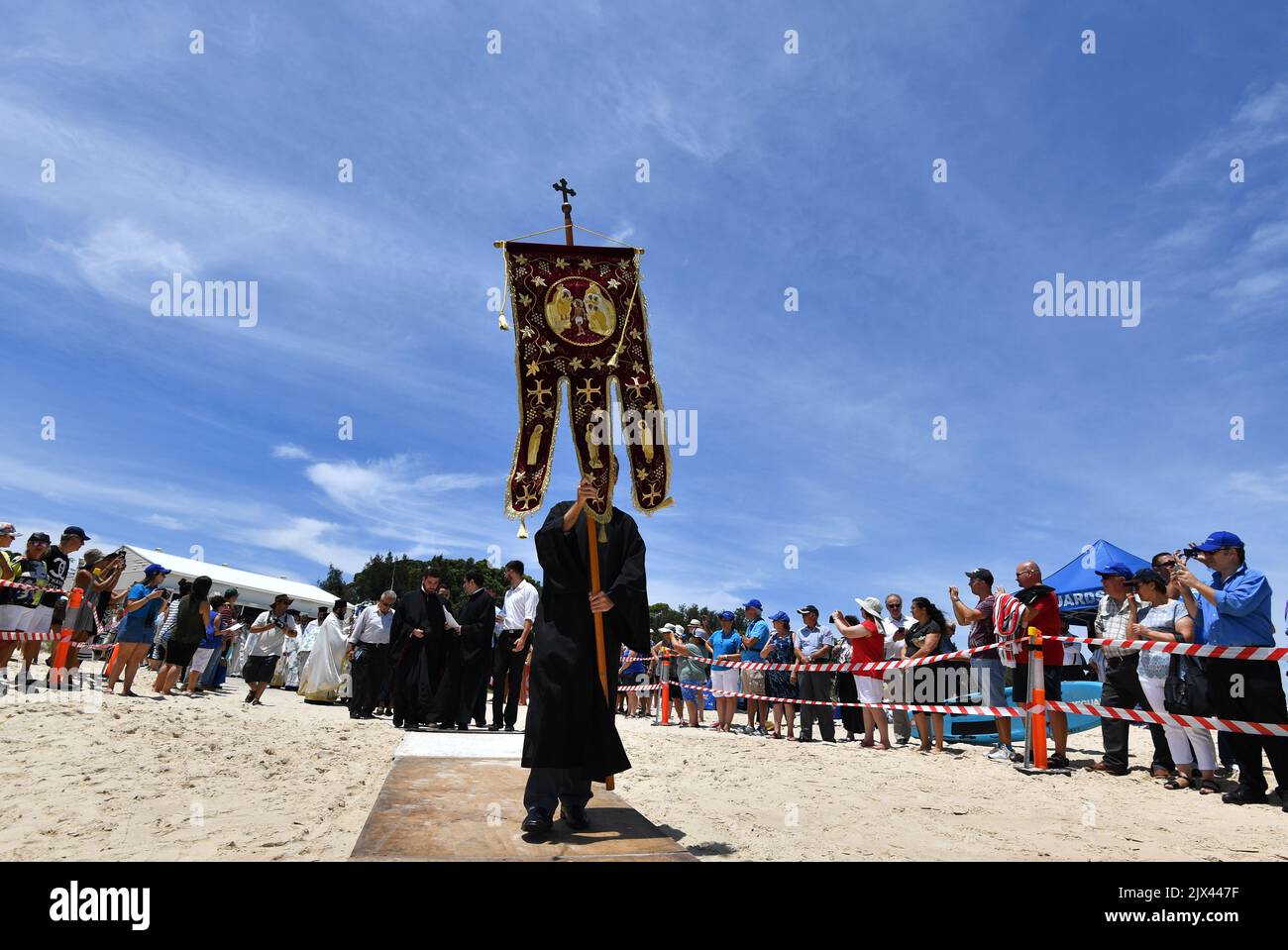 A Greek Orthodox altar boy carries the Orthodox banner to mark the ...