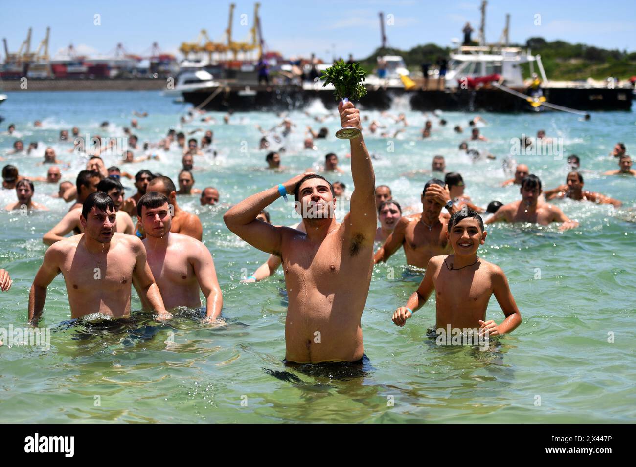 Peter Pavlakis of Kingsford, hold the cross he retrieved during the Festival of the Epiphany at ...