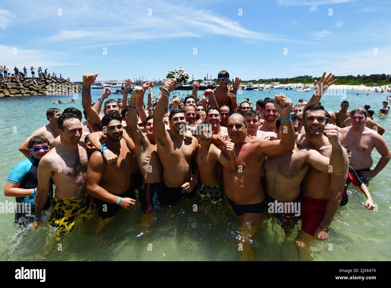 Peter Pavlakis of Kingsford (C) holds the cross, with other swimmers during the Festival of the ...