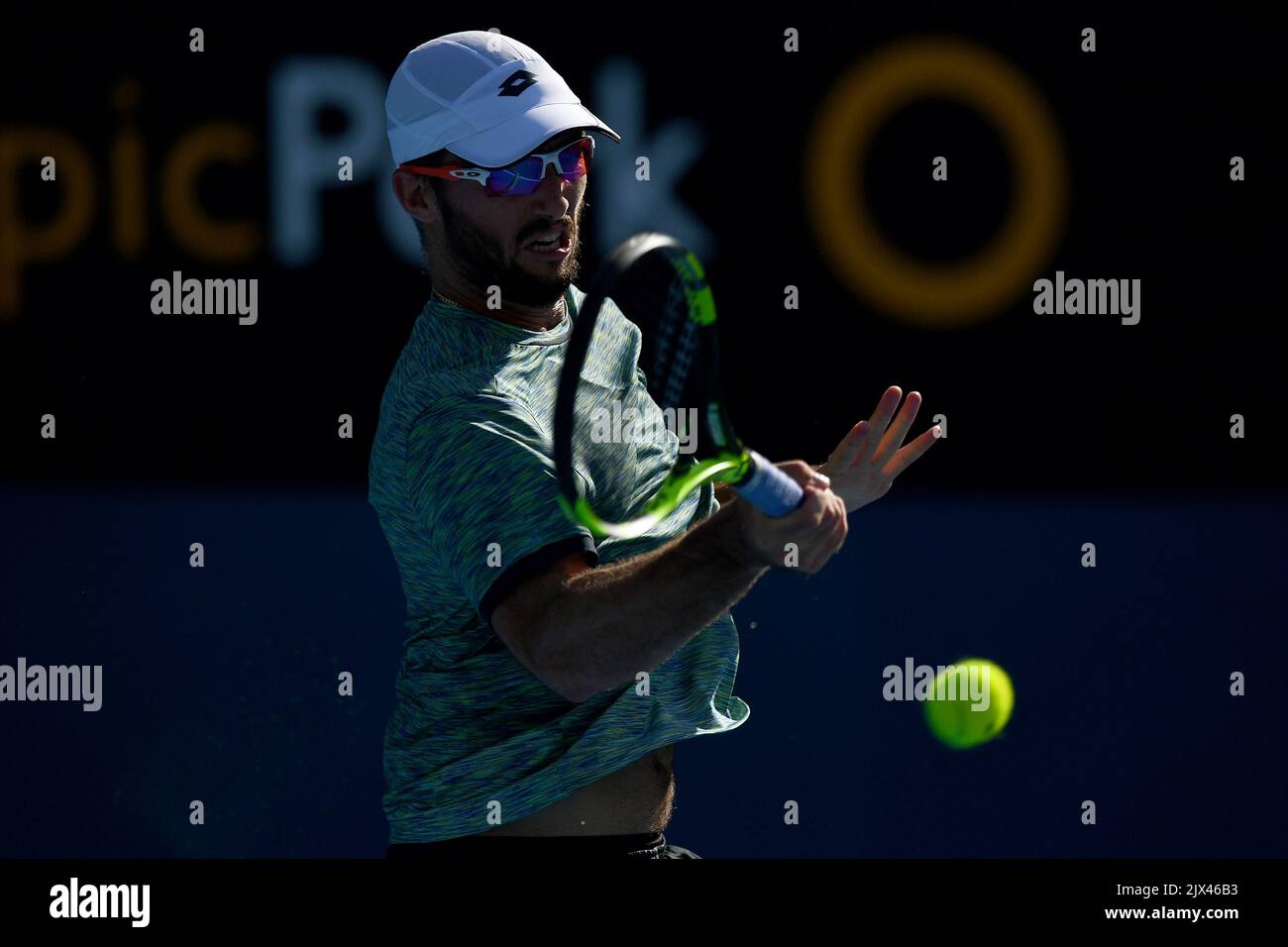 Viktor Troicki of Serbia returns a shot to Gilles Muller of Luxembourg ...