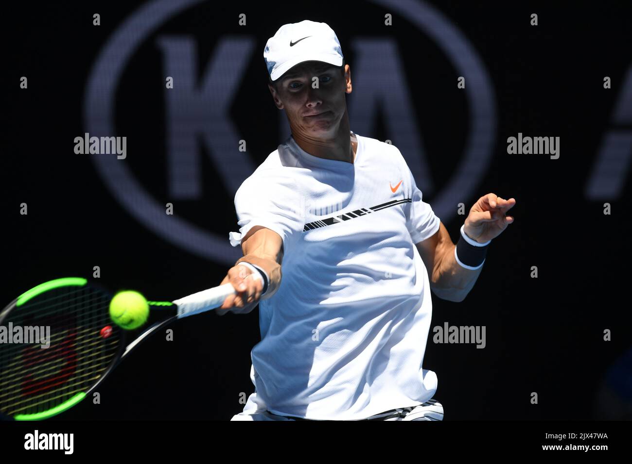 Andrey Kuznetsov of Russia plays a shot against Kei Nishikori of Japan the Round 1 of the Mens ...