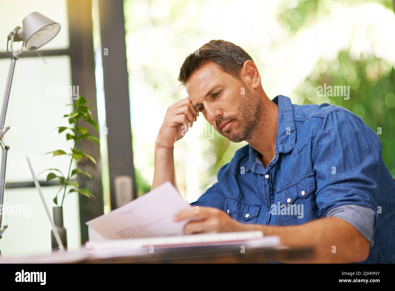 Dedicated to his business. a man looking over some paperwork while ...