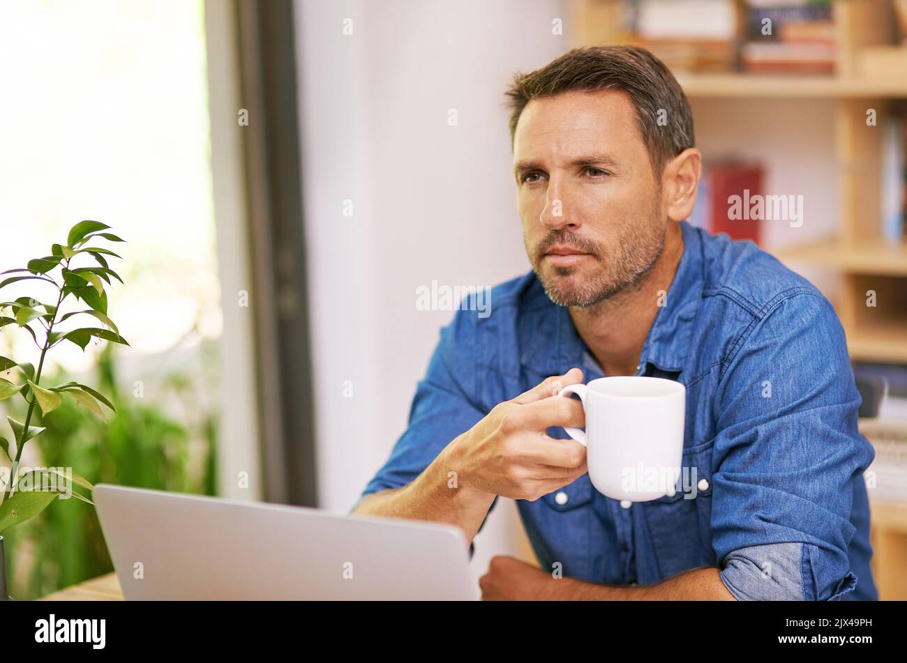 Fueling up on some caffeine before starting the workday. A young woman ...