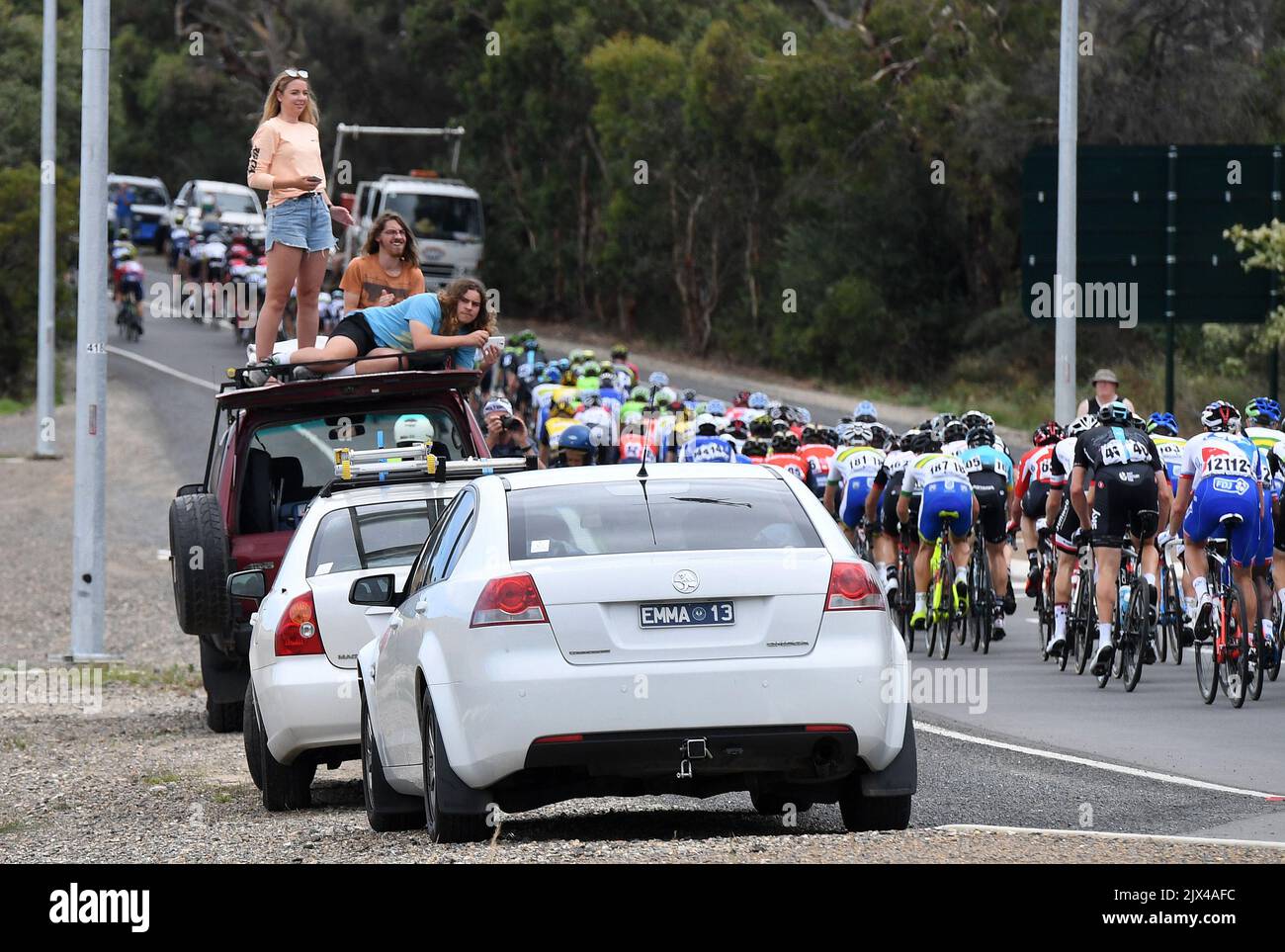 Spectators watch the peloton passing through near Victor Harbor during ...