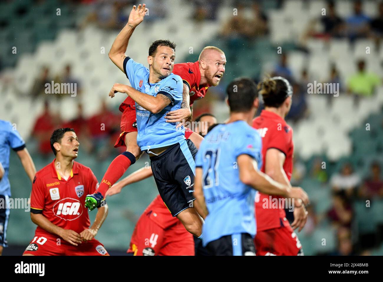 Bobo of Sydney competes to head the ball with Taylor Regan of United ...
