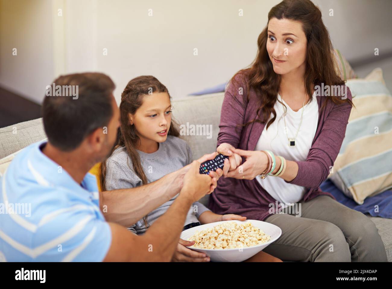 I think its the girls turn tonight. a young family watching a movie ...