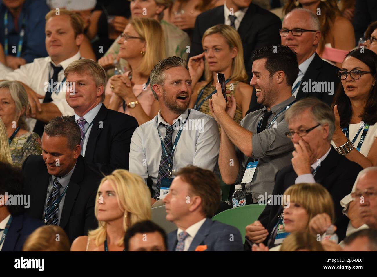 Australian actor Stephen Curry (centre) is seen watching Roger Federer ...