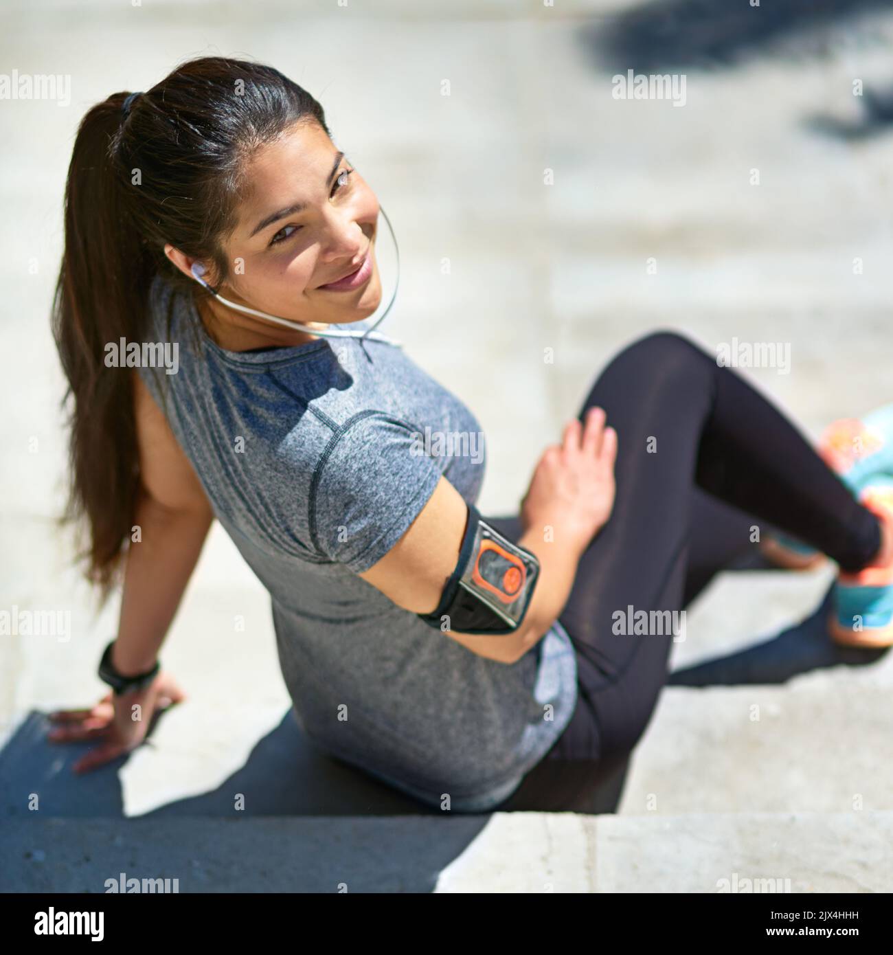Steadily improving her fitness levels. a sporty young woman listening ...