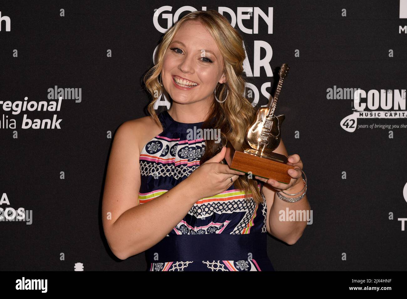 Kristy Cox poses for a photograph after receiving the Golden Guitar ...