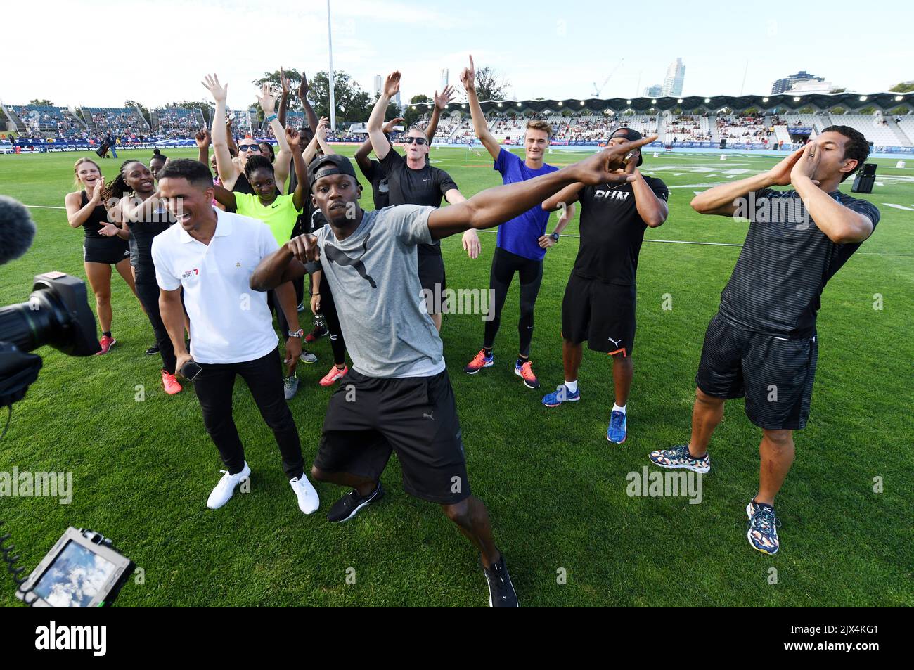 Jamaican sprinter Usain Bolt (centre) poses in his signature move after ...