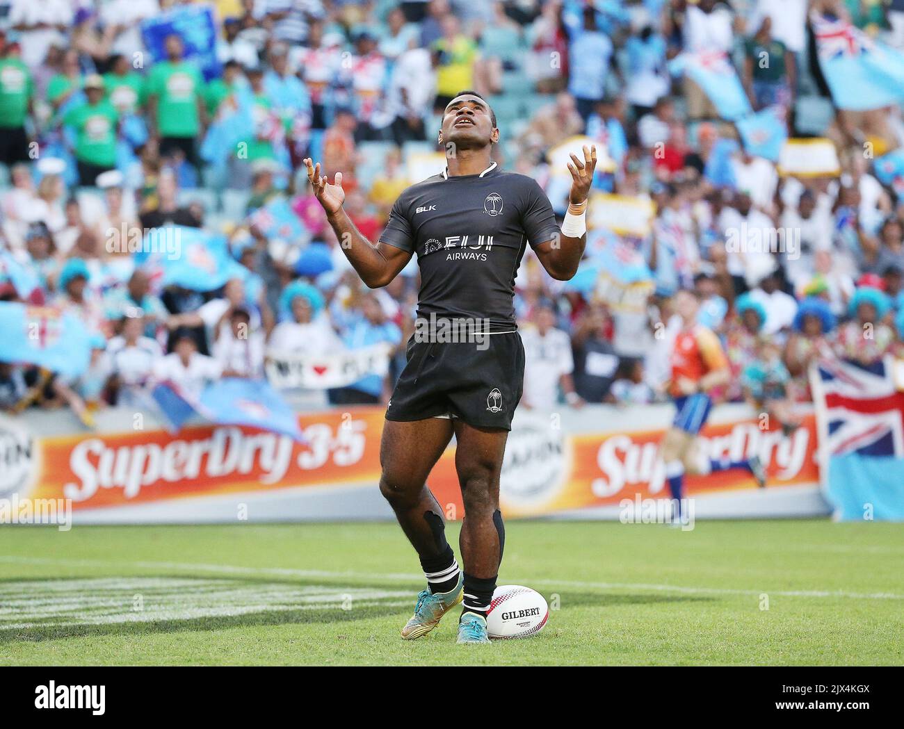 Fiji's Jerry Tuwai gestures to the sky after scoring a try against ...