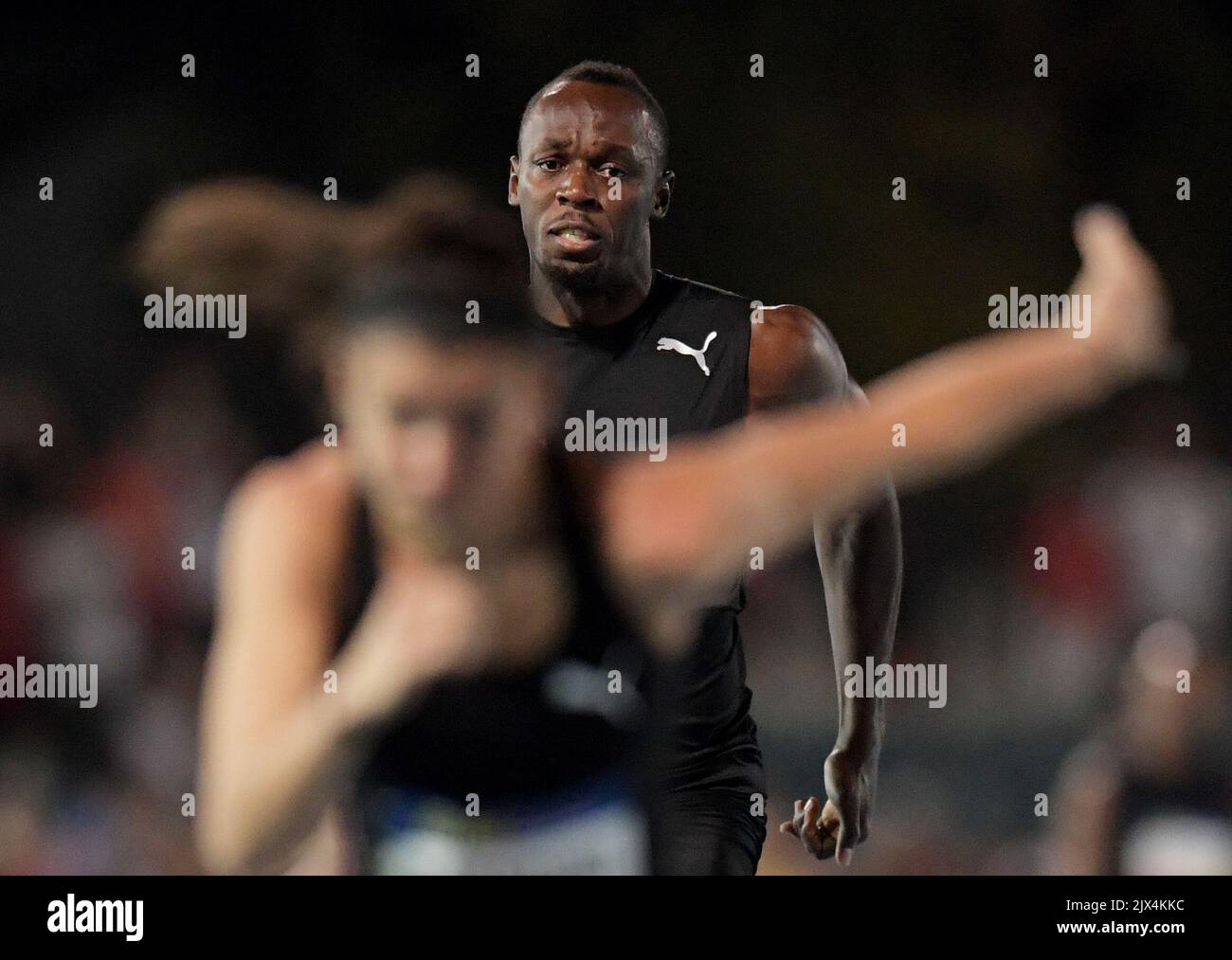 Jamaican sprinter Usain Bolt passes the button to Jenna Prandini of the ...