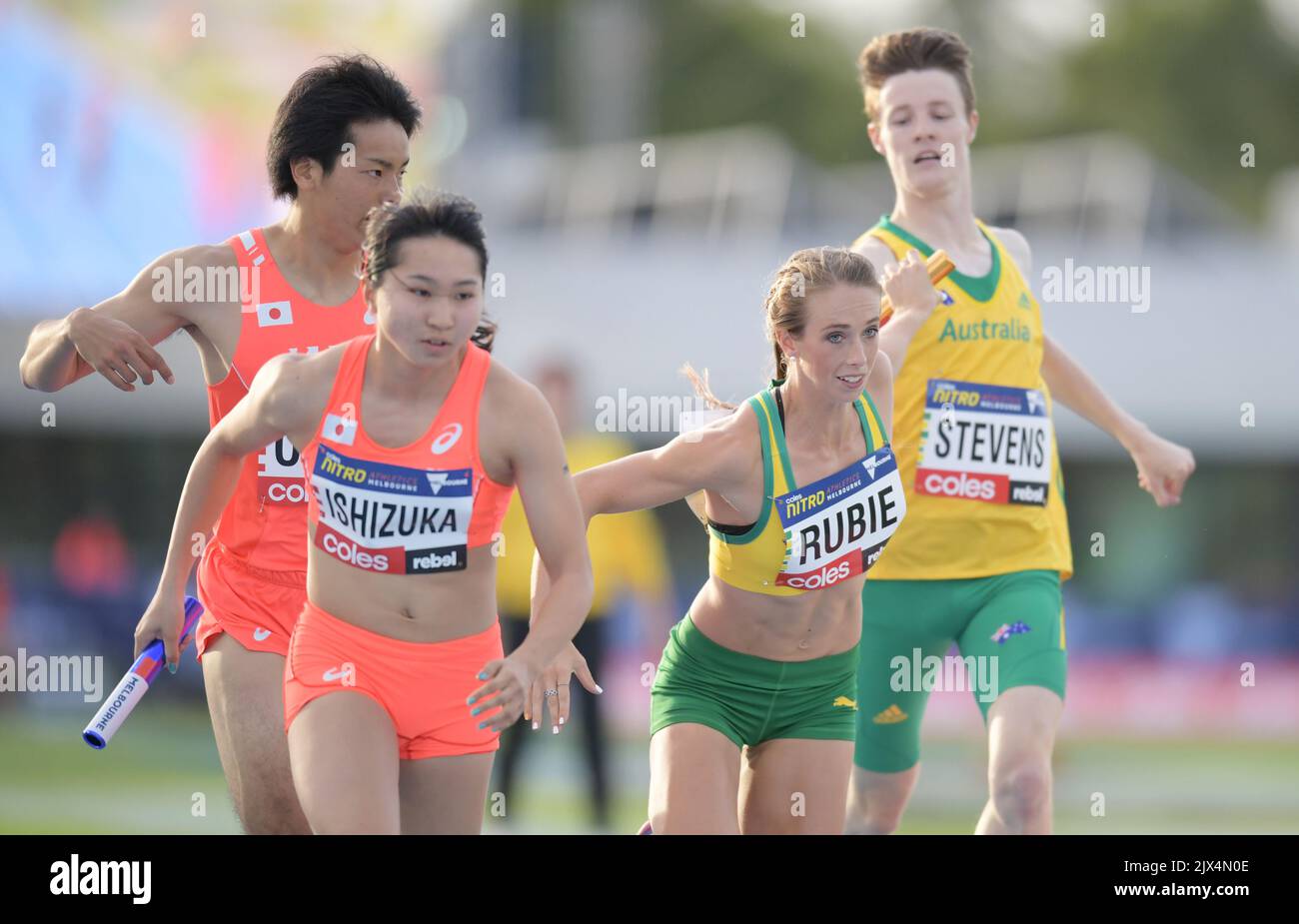 Australian athlete Annaliese Rubie takes the button from Luke Stevens as Kazuma passes to ...