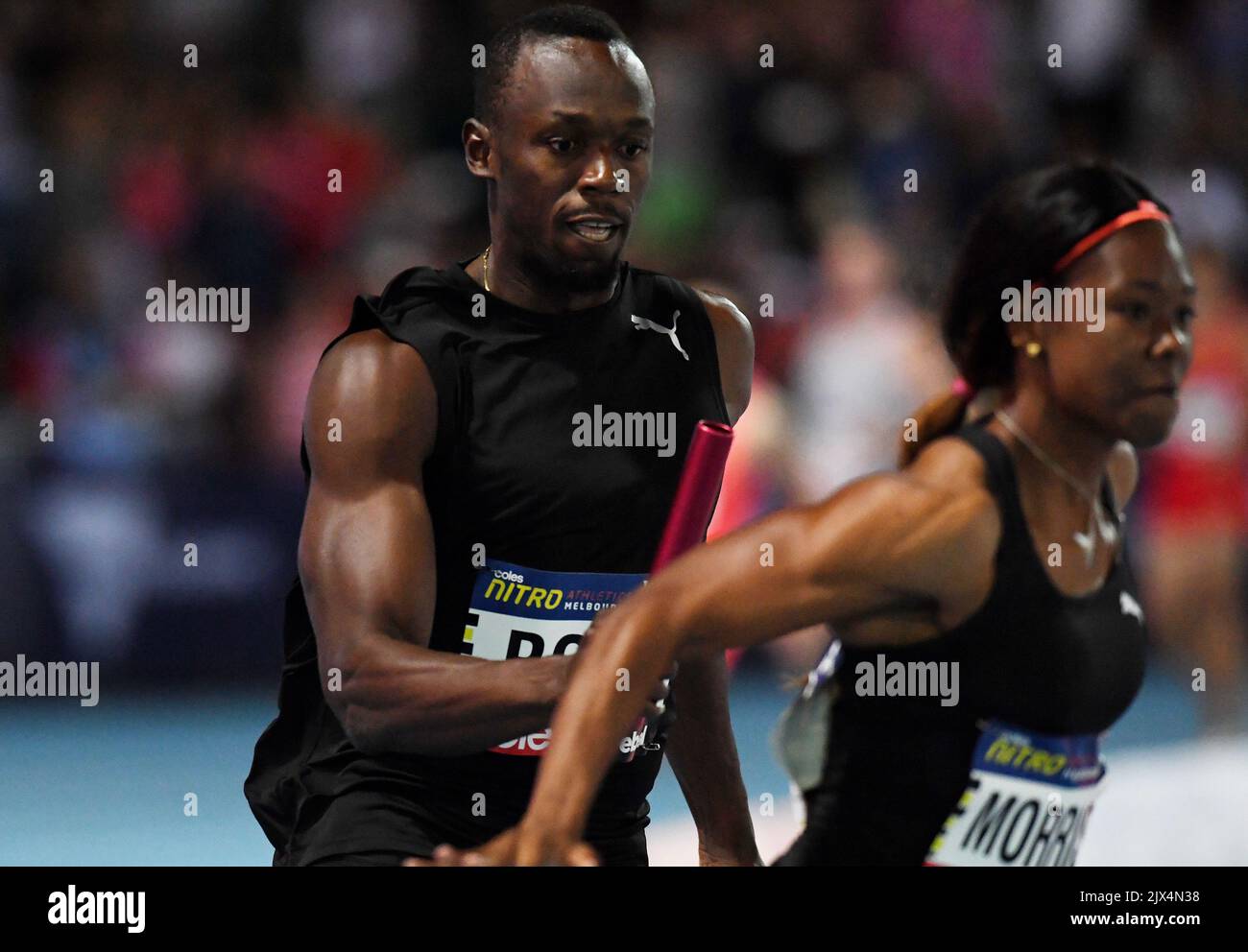 Jamaican sprinter Usain Bolt passes the button to Jenna Prandini in the ...