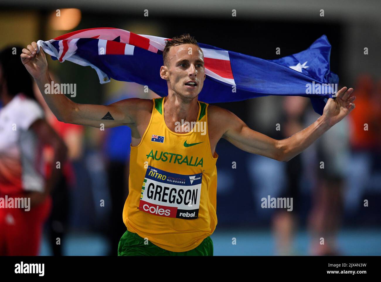 Australian athlete Ryan Greyson runs with the Australian flag after ...