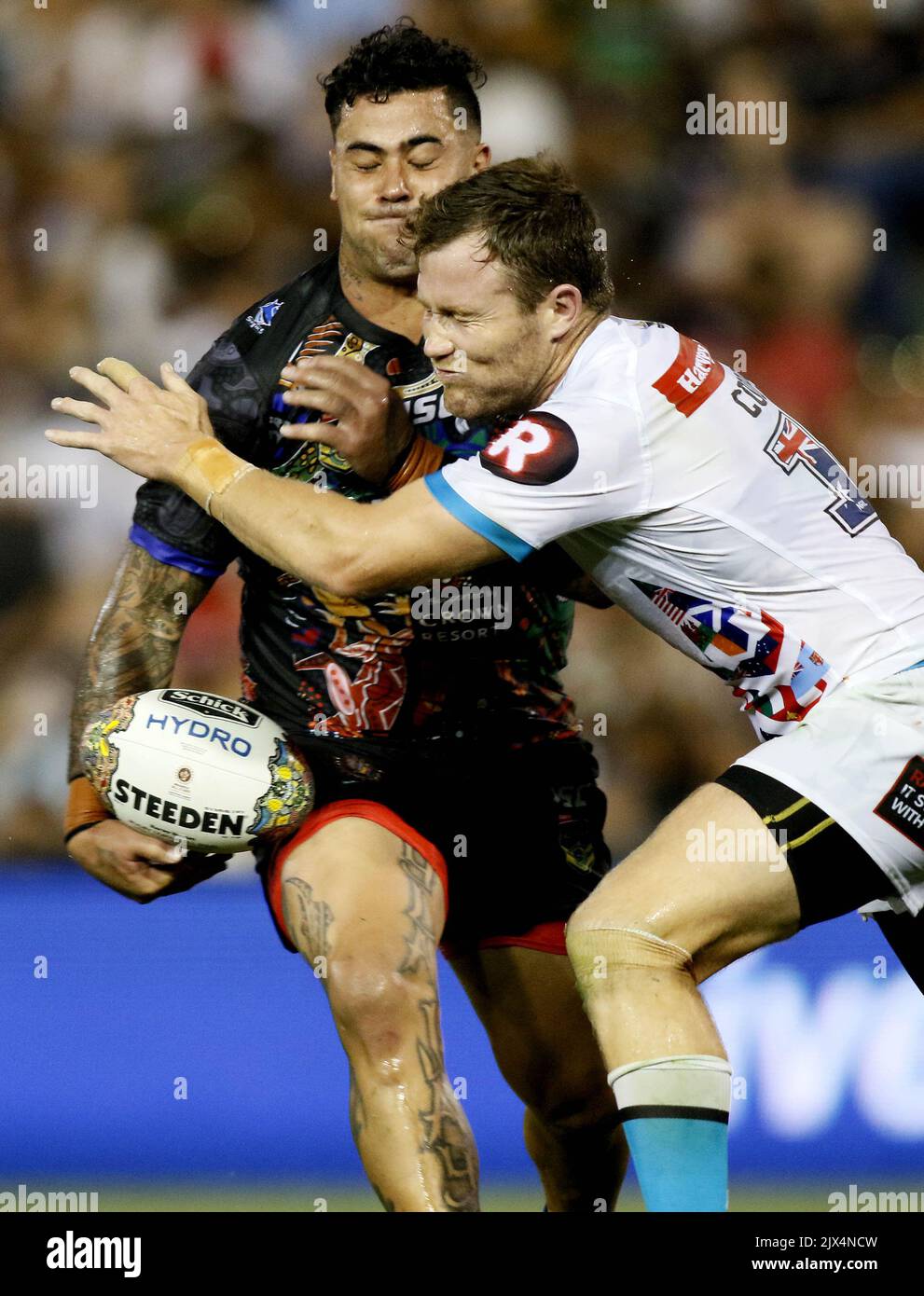 Andrew Fifita of the Indigenous All Stars is tackled by Gavin Cooper of the World All Stars ...