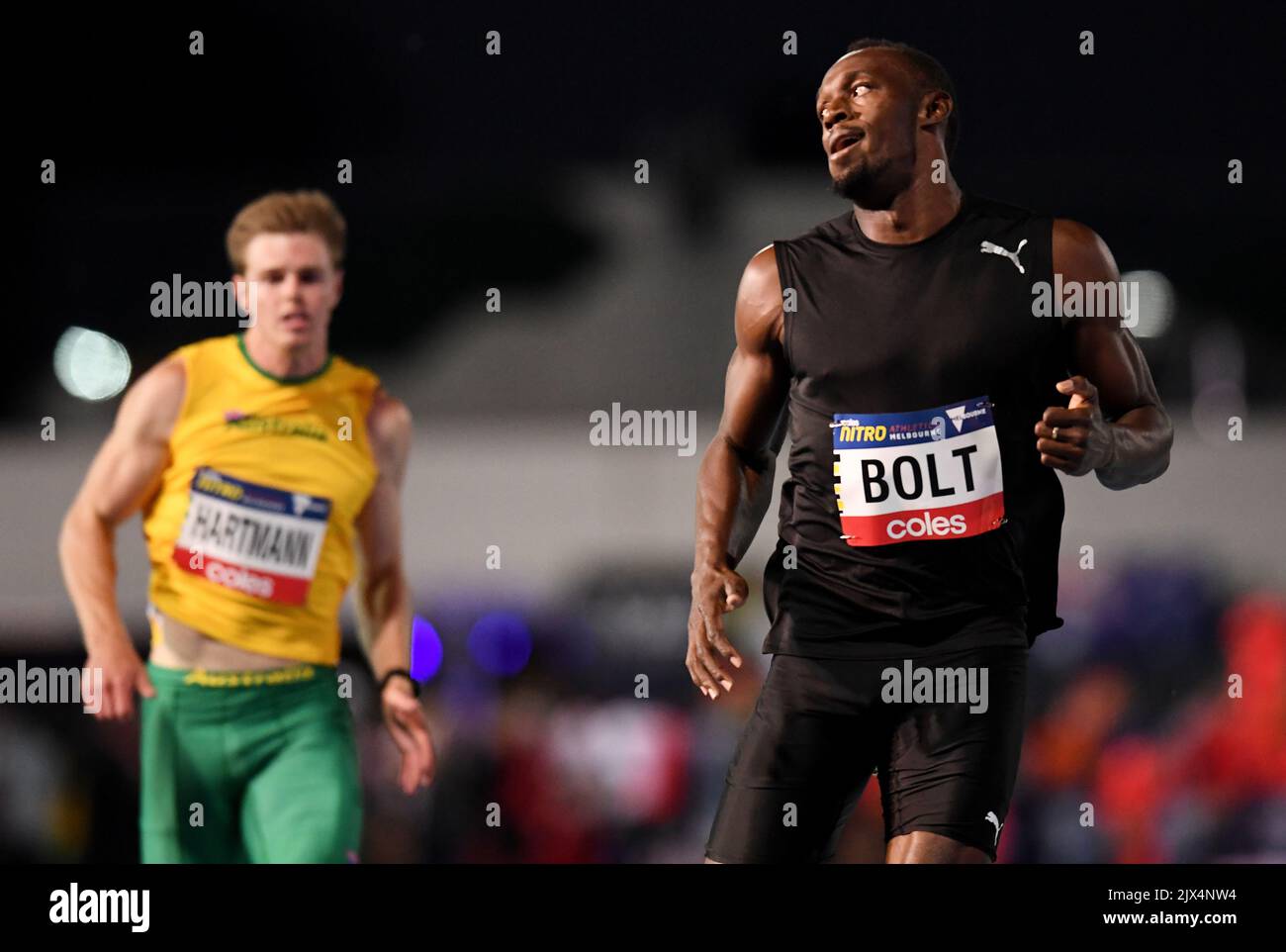 Jamaican sprinter Usain Bolt looks over his shoulder to Australian ...