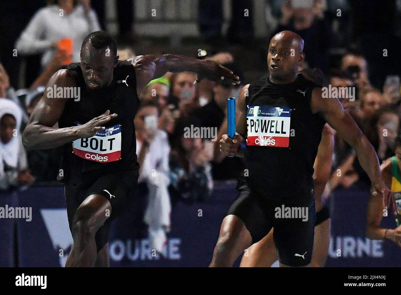 American sprinter Asafa Powell passes the baton to Jamaican sprinter ...