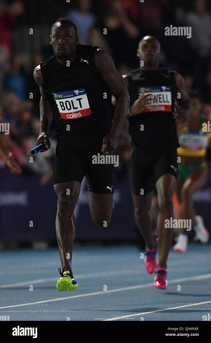 American sprinter Asafa Powell passes the baton to Jamaican sprinter ...
