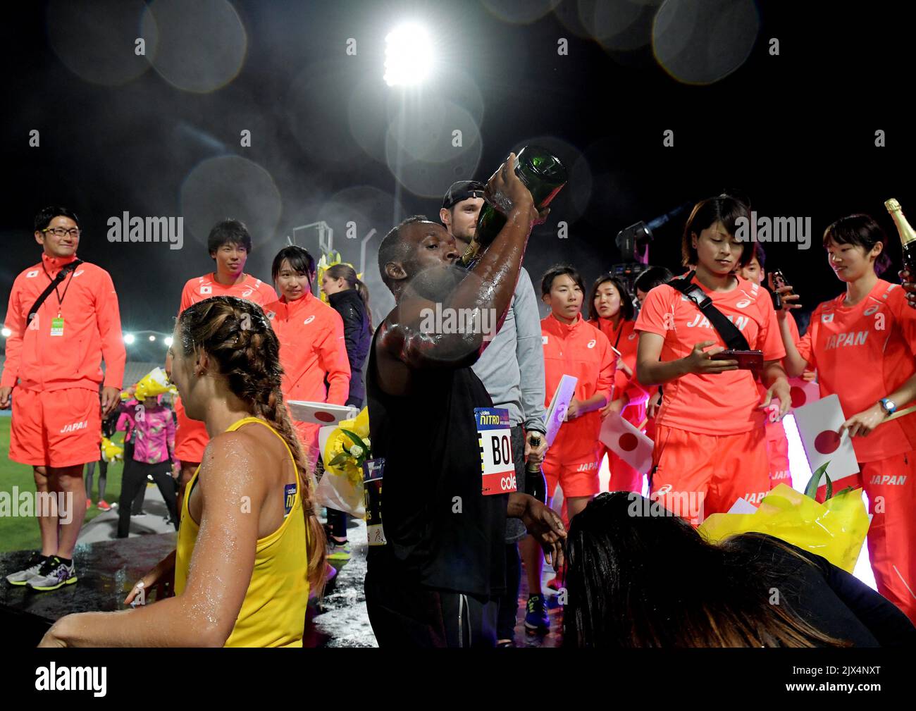 Jamaican sprinter Usain Bolt drinks a bottle of champagne after the ...