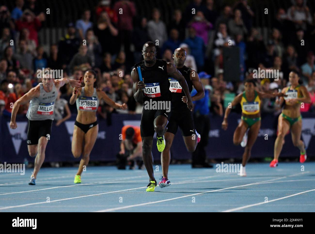 American sprinter Asafa Powell passes the baton to Jamaican sprinter ...