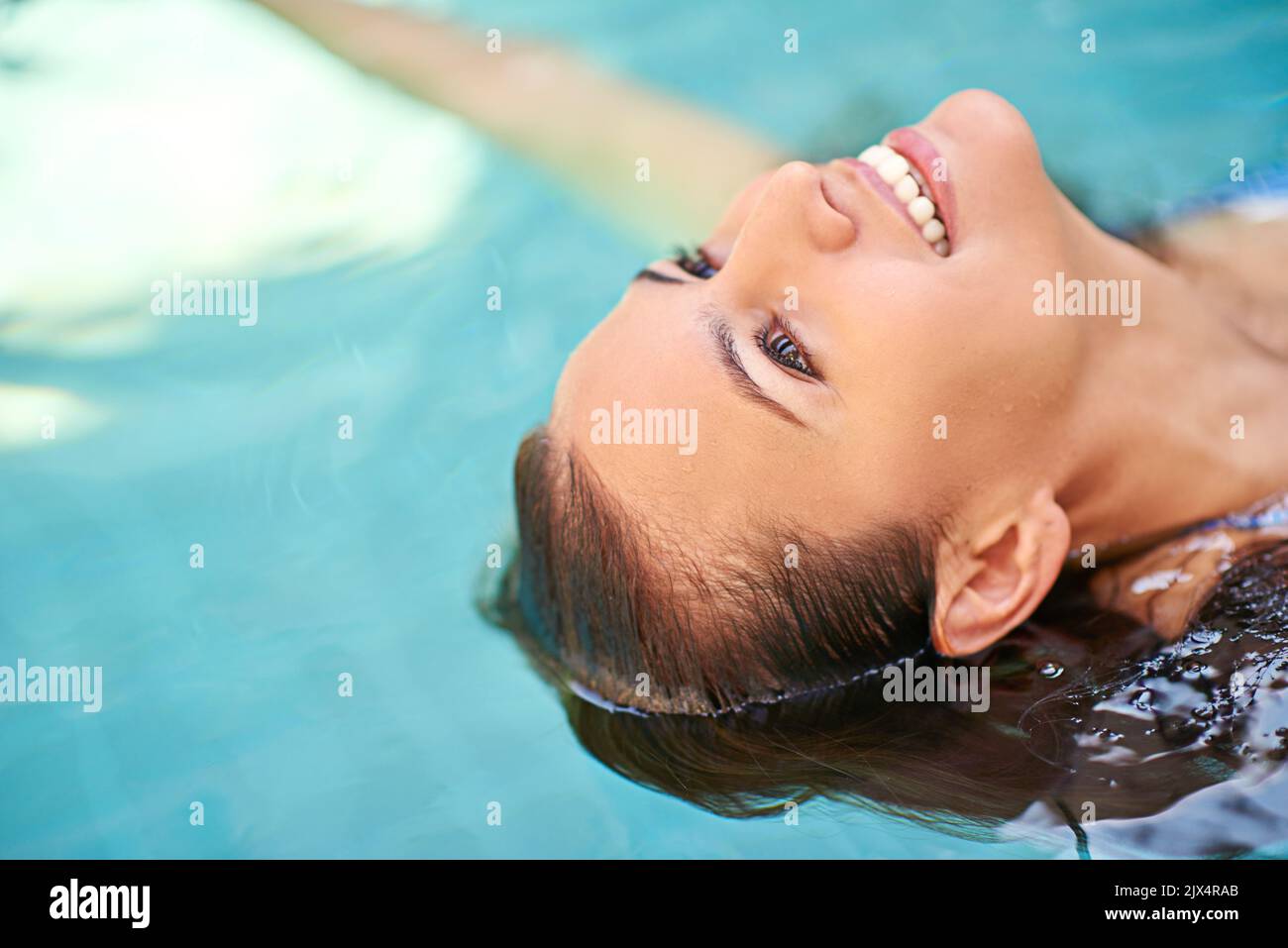 Just floating around. a young woman relaxing in the pool at a spa Stock ...