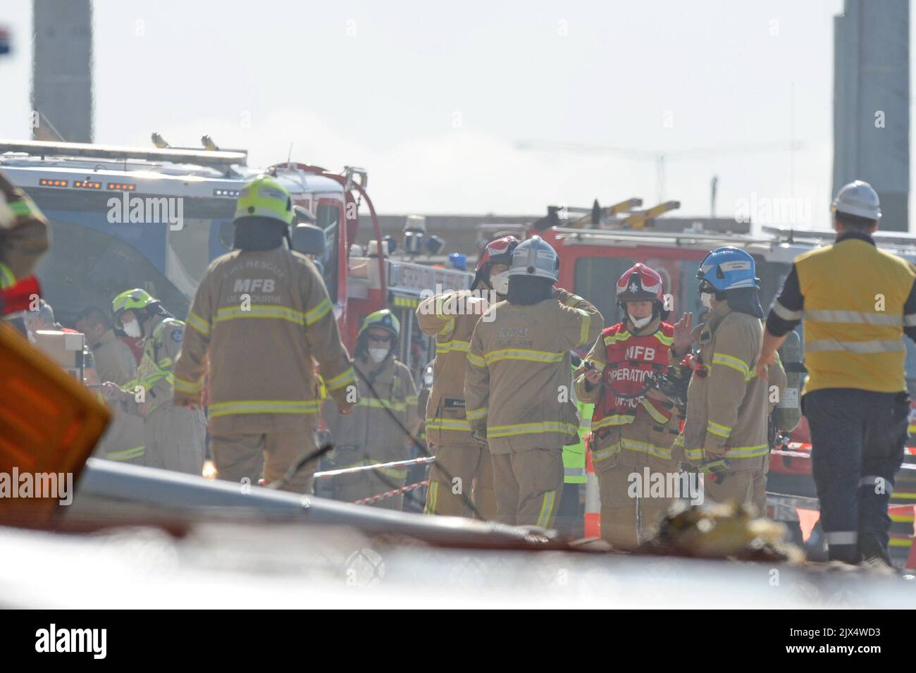 Emergency services personnel are seen at the scene of a plane crash in ...