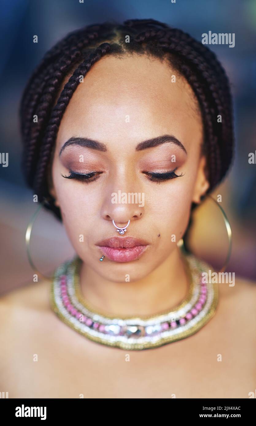 Adorning her body with beauty. an attractive young woman with piercings ...