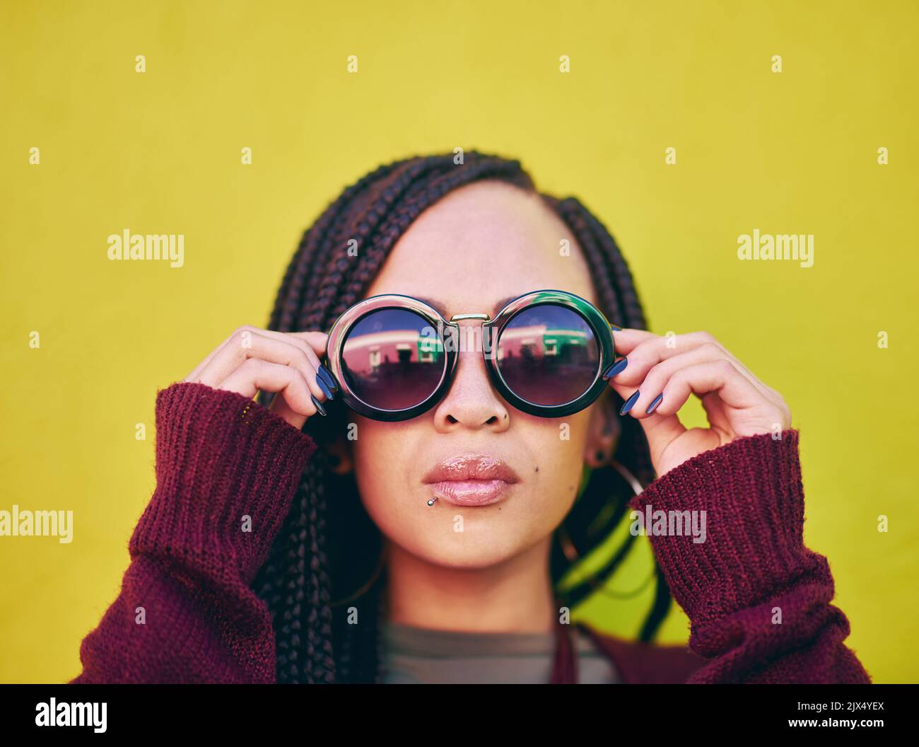 Im cool like that. a young woman wearing sunglasses against a green ...