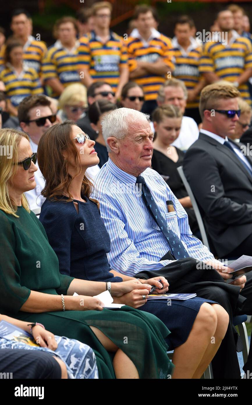 Dan Vickerman's wife, Sarah (centre), looks upward at a public memorial ...