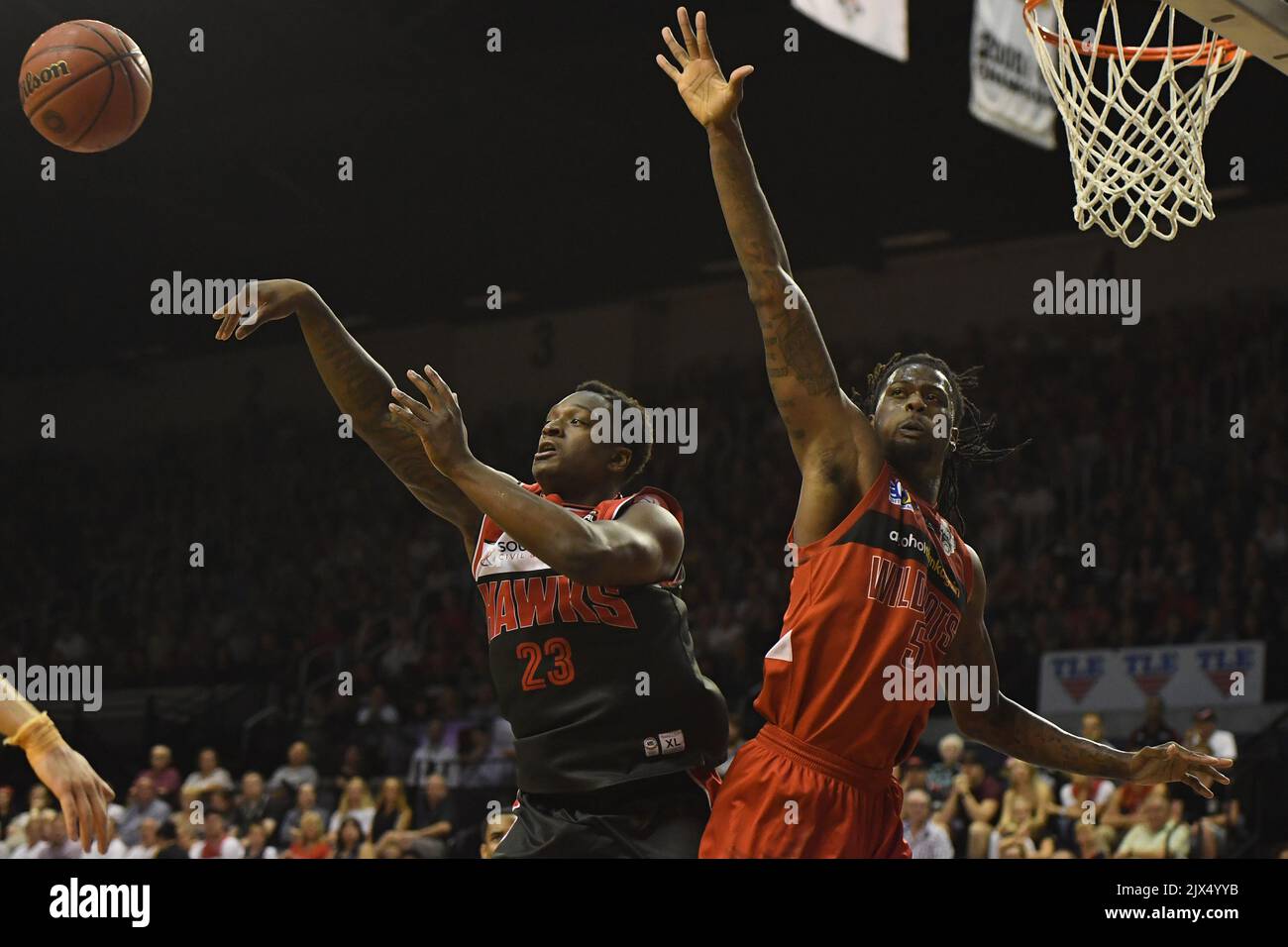 Marvelle Harris of the Hawks and James McKay of the Wildcats in action ...
