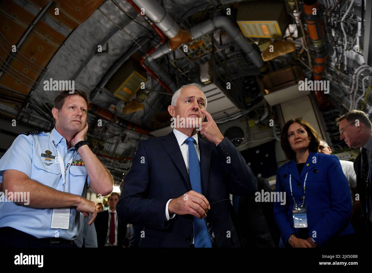 Australian Prime Minister Malcolm Turnbull (centre) tours the back of a ...