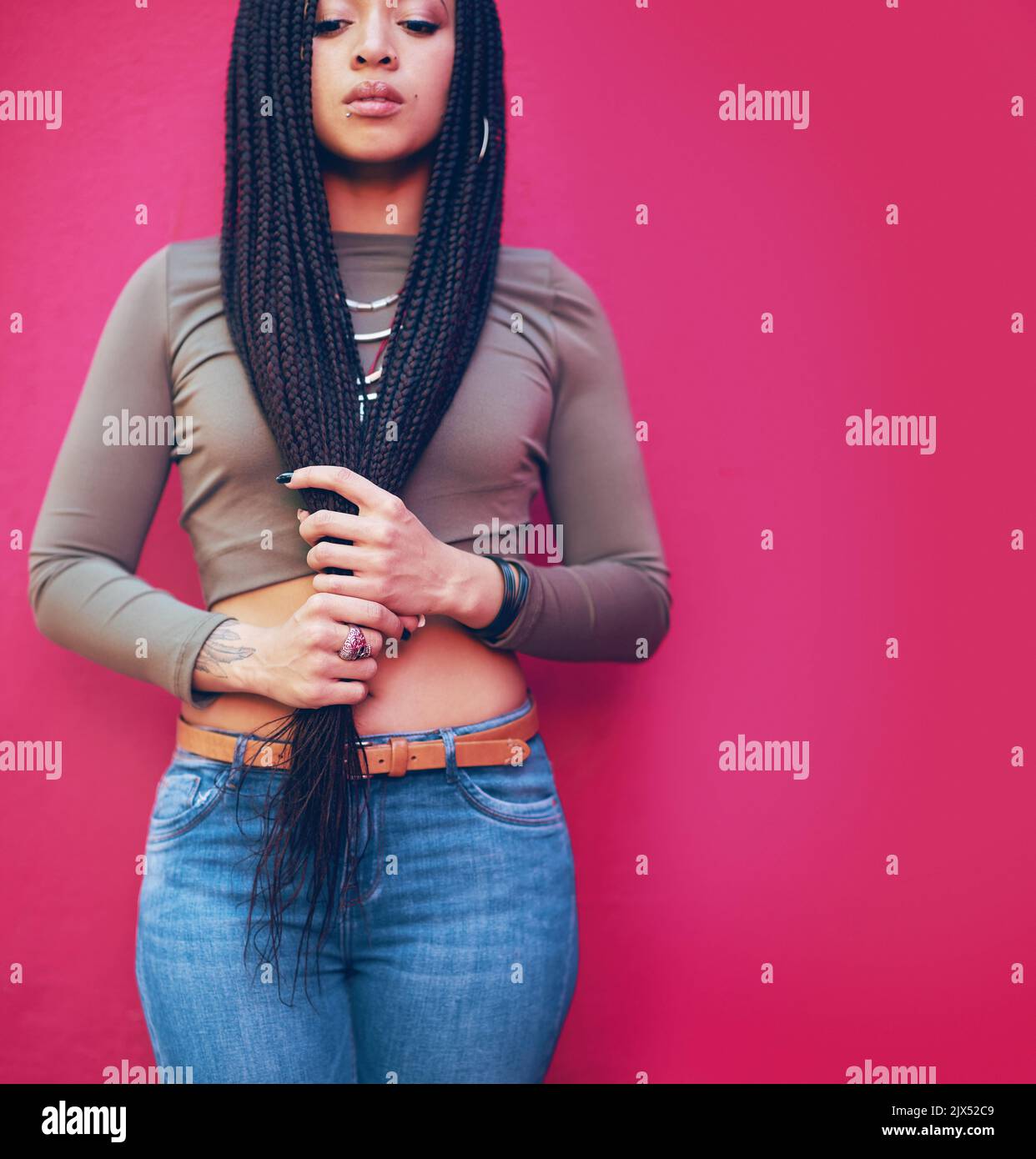 Be your own kind of beautiful. a young woman with braids posing against ...